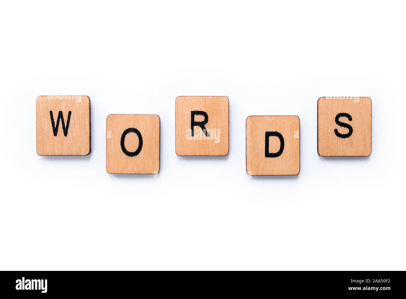 The word WORDS, spelt with wooden letter tiles over a white background ...