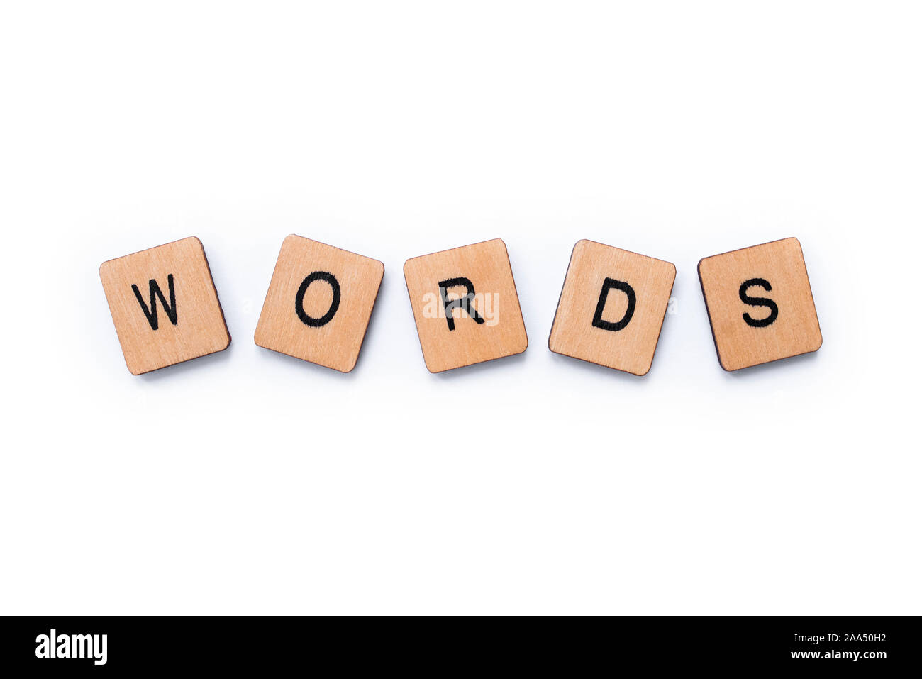 The word WORDS, spelt with wooden letter tiles over a white background ...