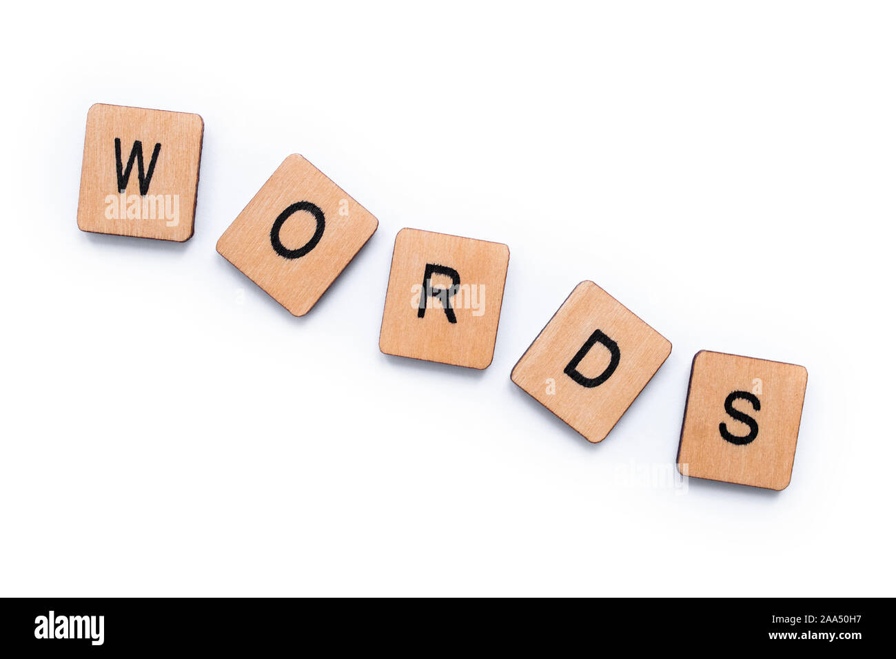The word WORDS, spelt with wooden letter tiles over a white background ...