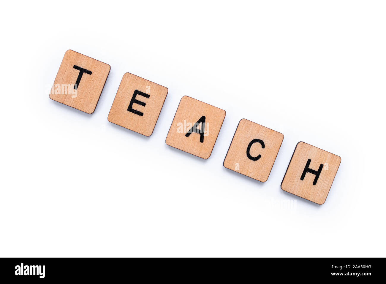 The word TEACH, spelt with wooden letter tiles over a white background ...