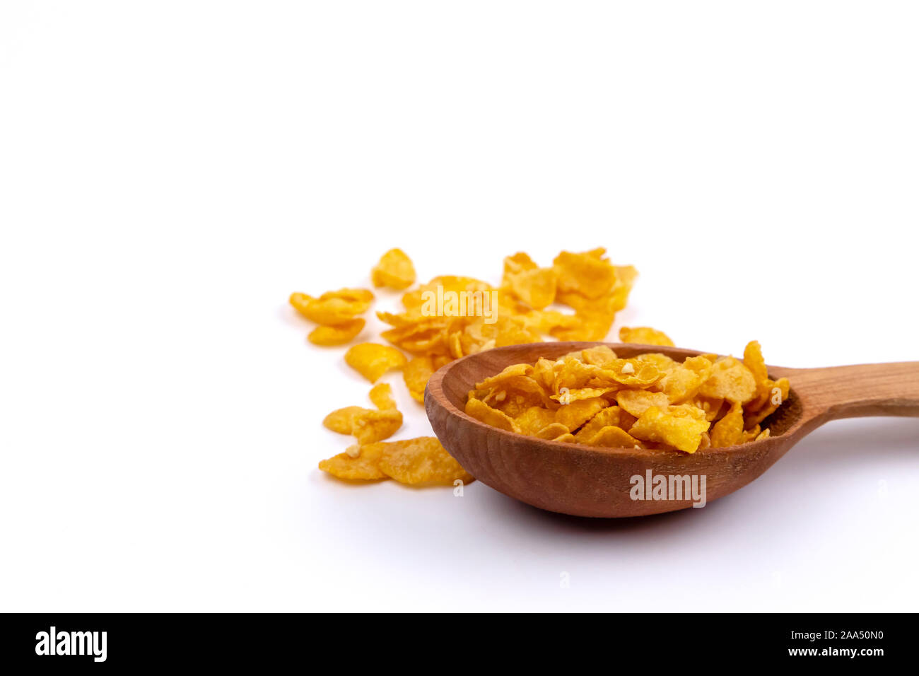 Crunchy corn flakes, cereal, muesli pile in wooden spoon isolated on ...