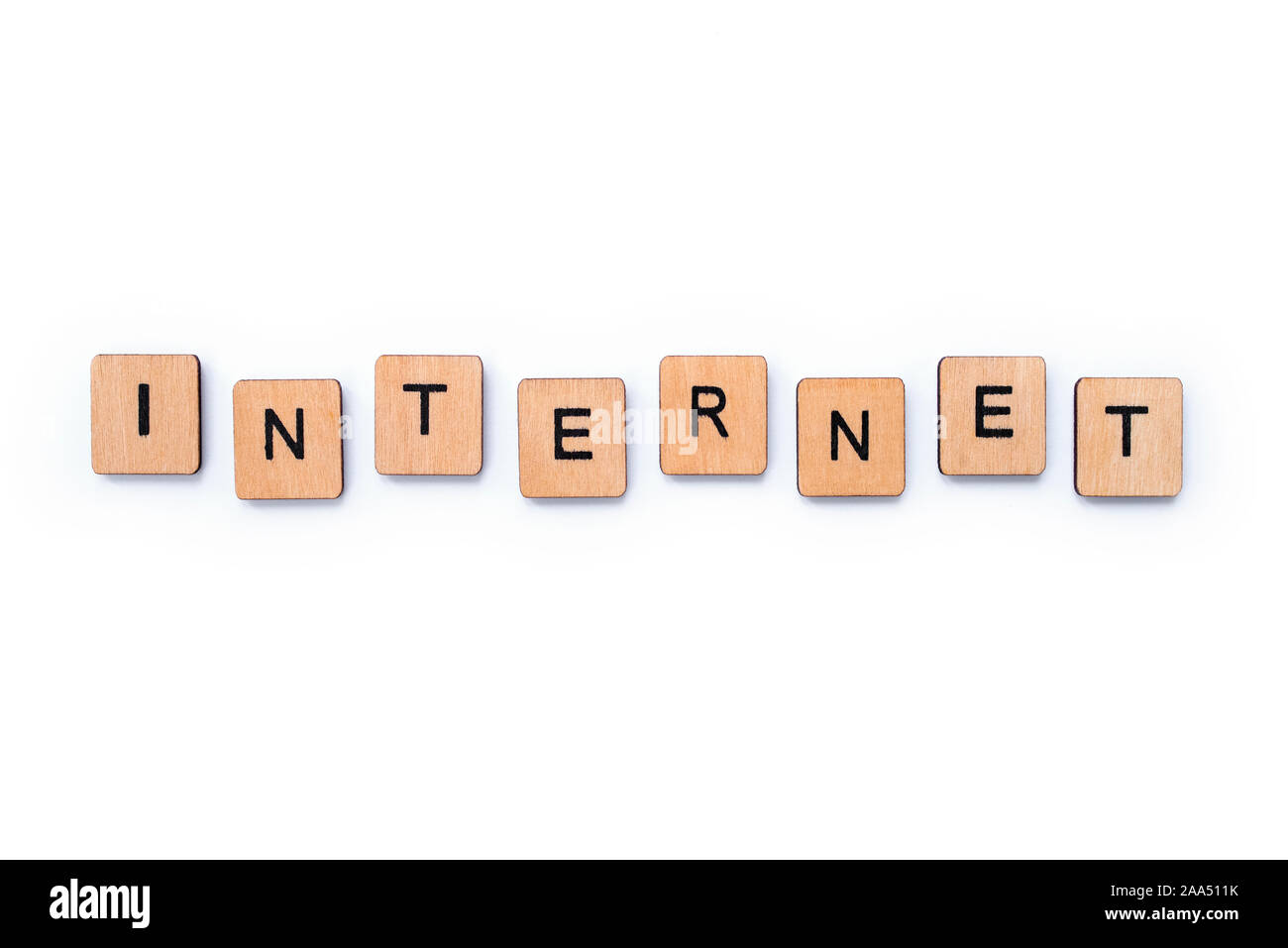 The word INTERNET, spelt with wooden letter tiles over a white ...