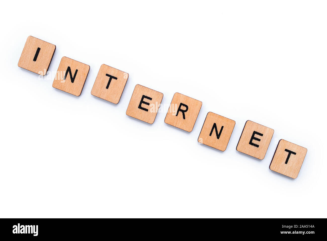 The word INTERNET, spelt with wooden letter tiles over a white ...