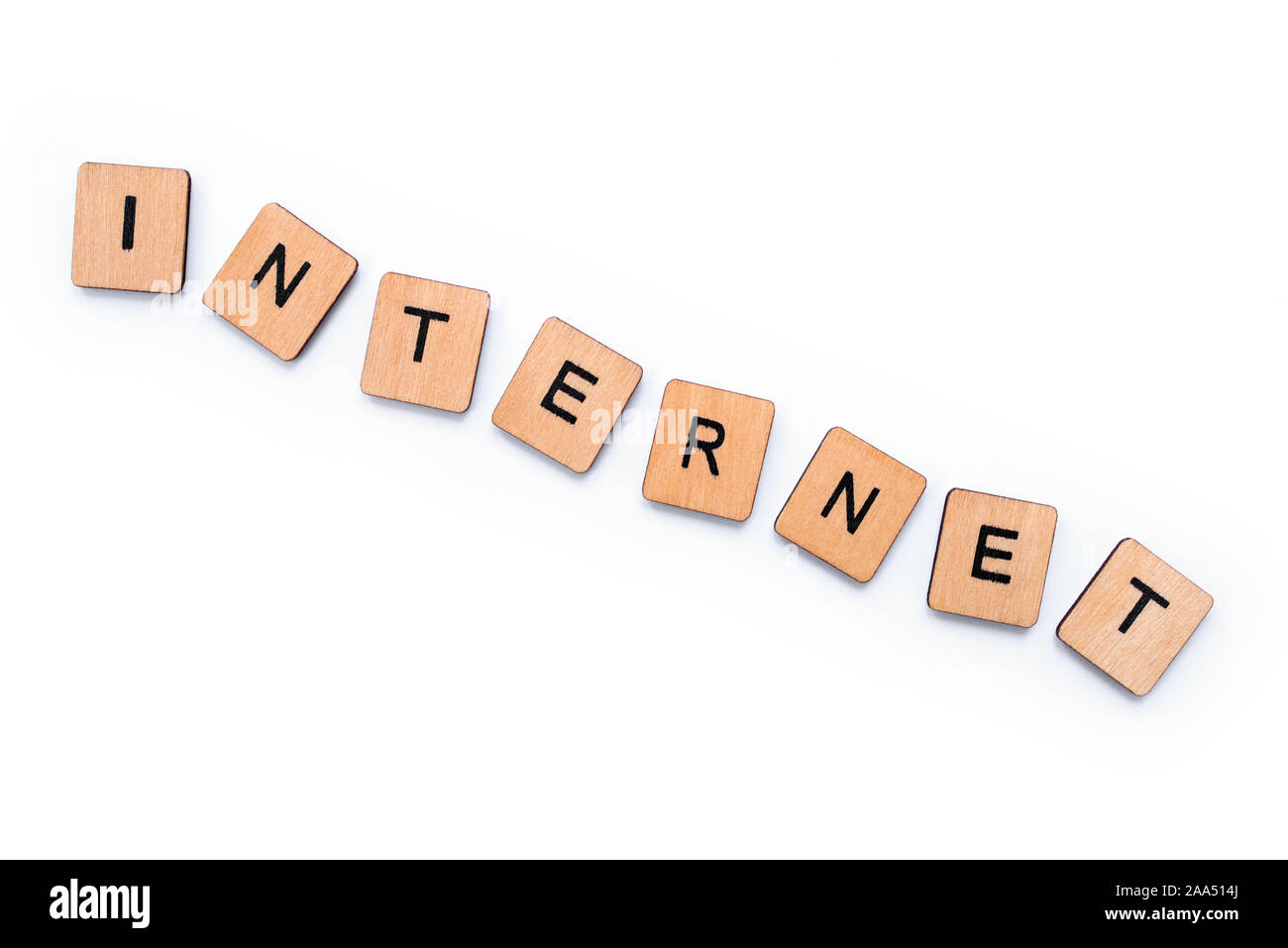 The word INTERNET, spelt with wooden letter tiles over a white ...