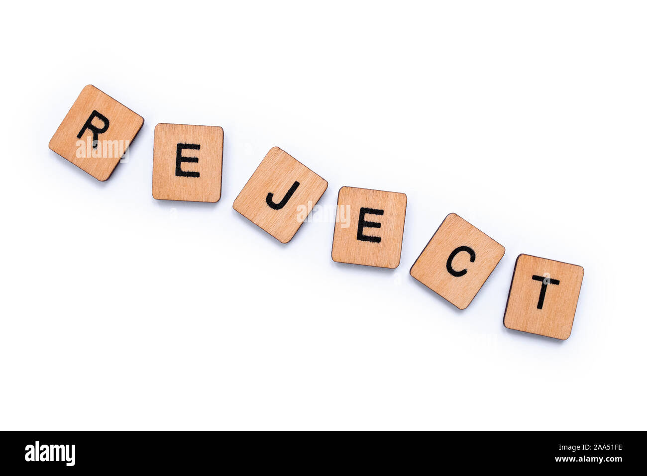 The word REJECT, spelt with wooden letter tiles over a white background ...