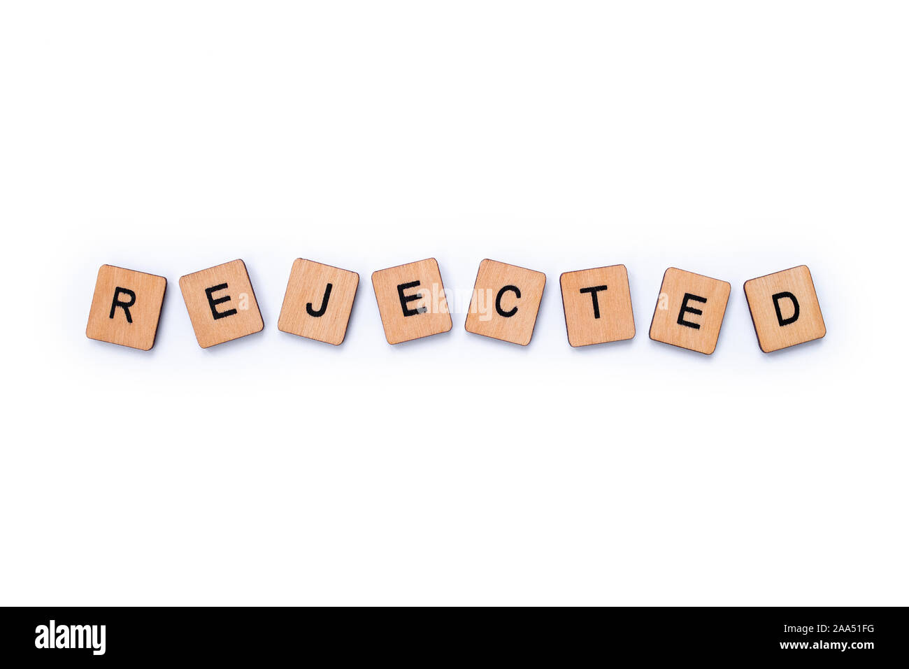 The word REJECTED, spelt with wooden letter tiles over a white ...