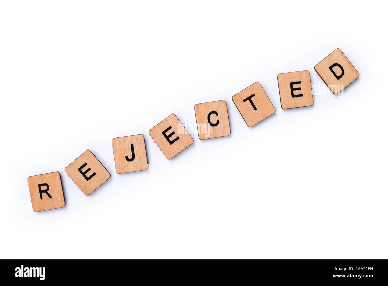 The word REJECTED, spelt with wooden letter tiles over a white ...