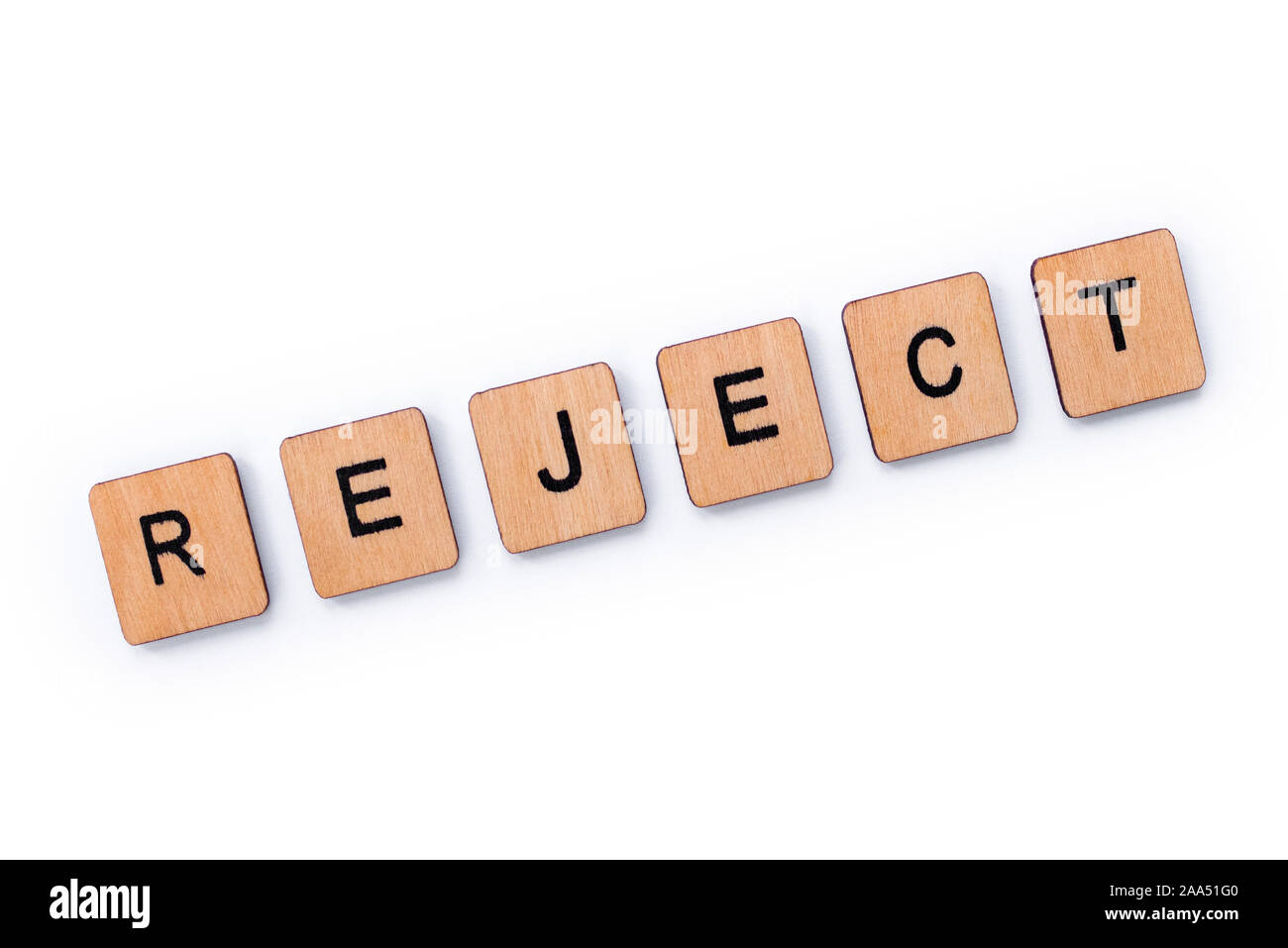 The word REJECT, spelt with wooden letter tiles over a white background ...