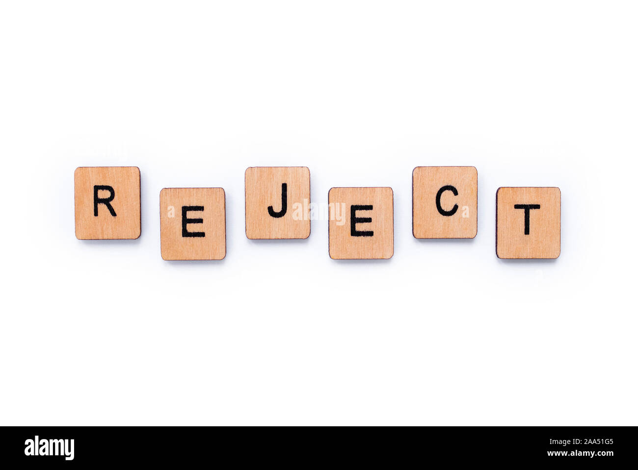 The word REJECT, spelt with wooden letter tiles over a white background ...
