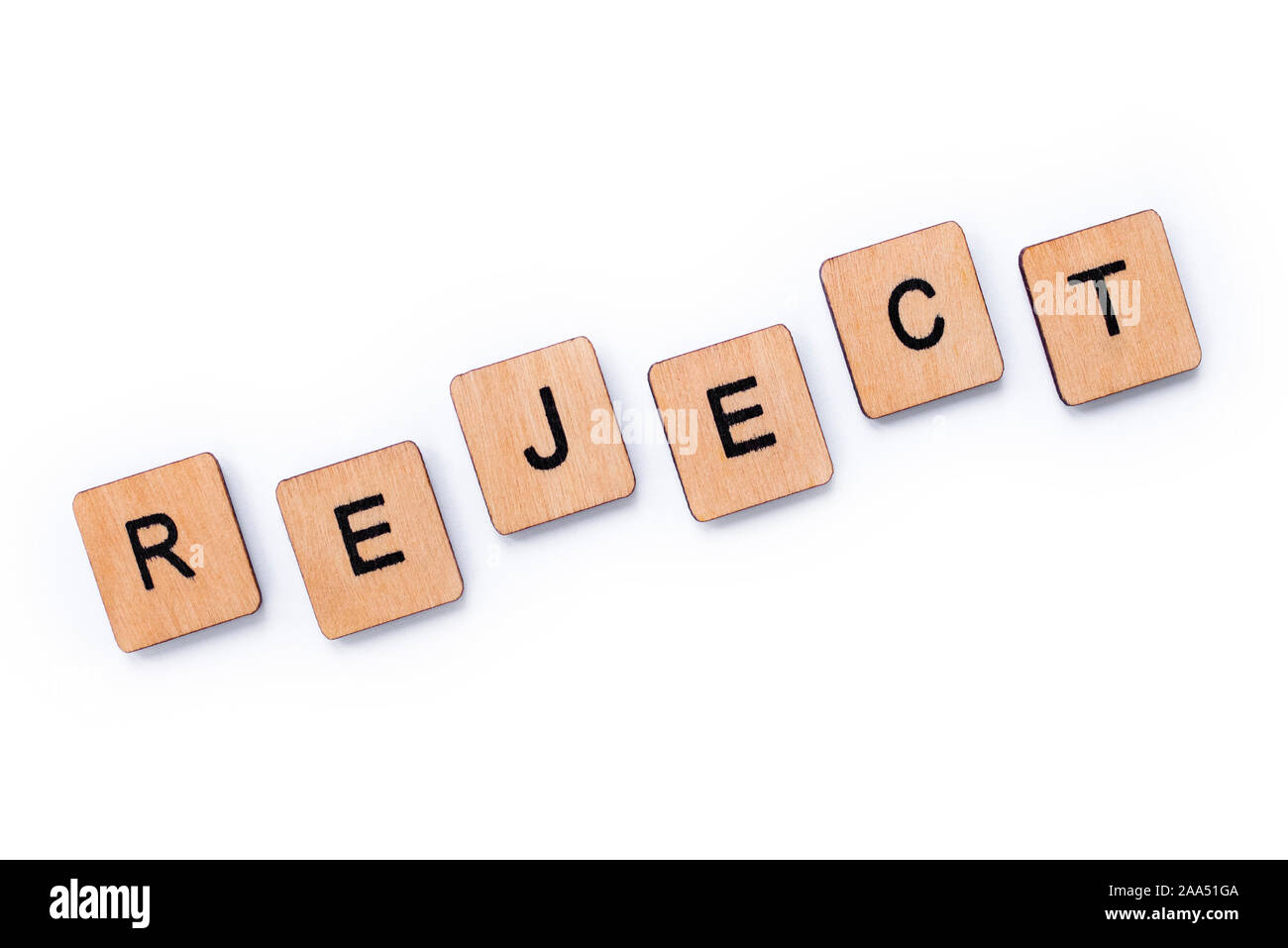 The word REJECT, spelt with wooden letter tiles over a white background ...