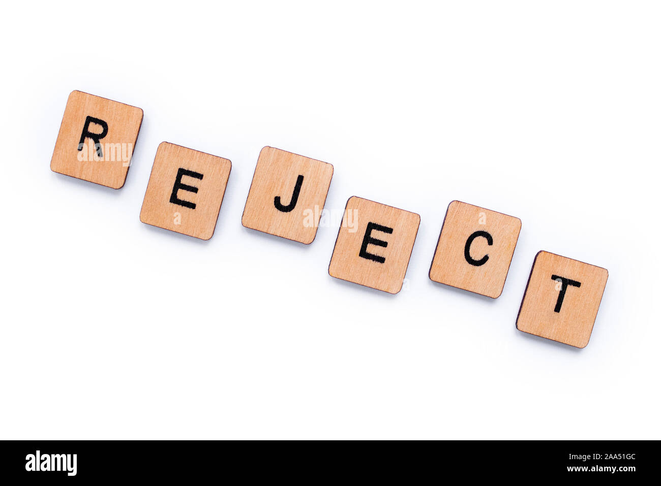 The word REJECT, spelt with wooden letter tiles over a white background ...