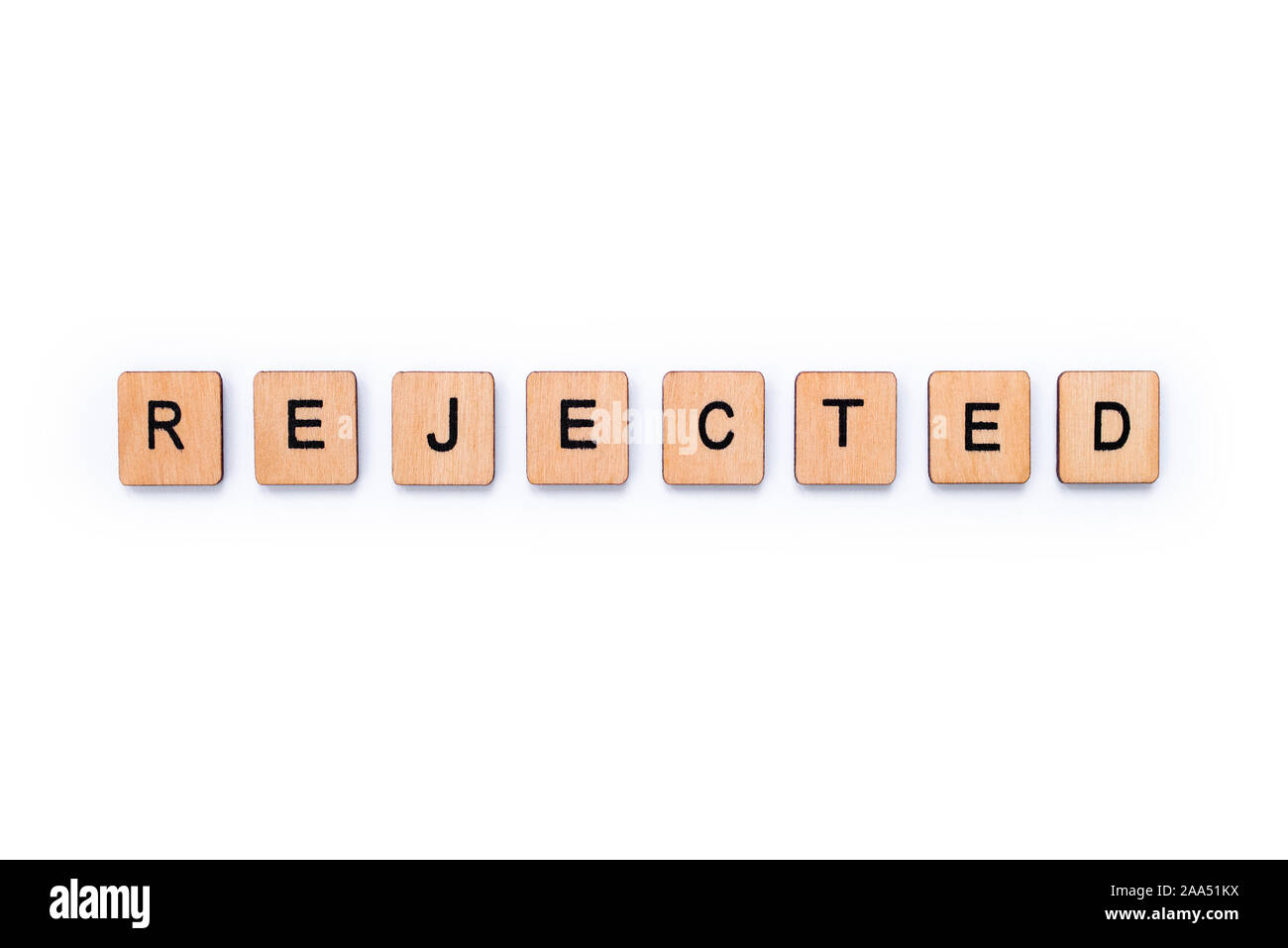The word REJECTED, spelt with wooden letter tiles over a white ...
