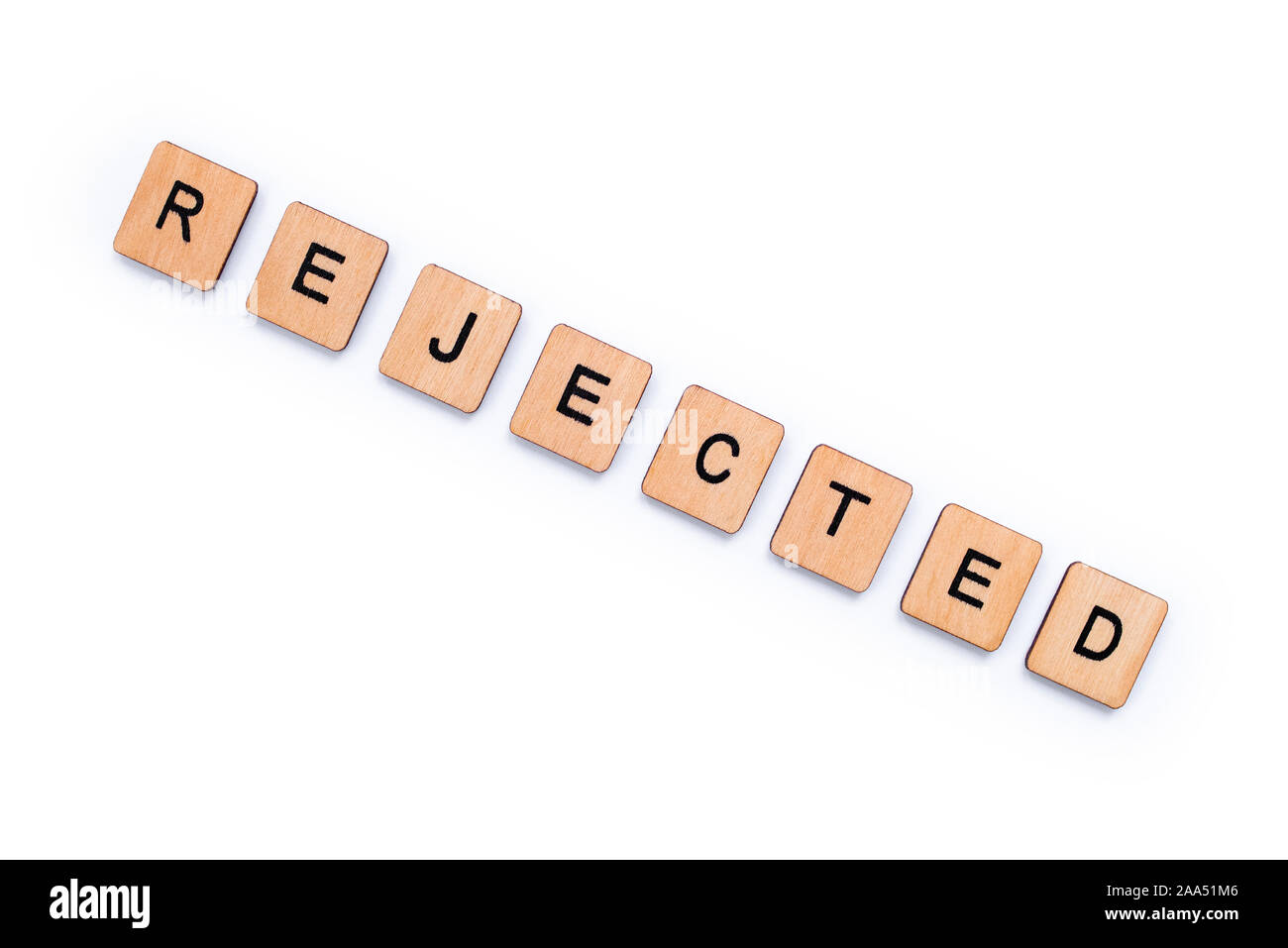 The word REJECTED, spelt with wooden letter tiles over a white ...