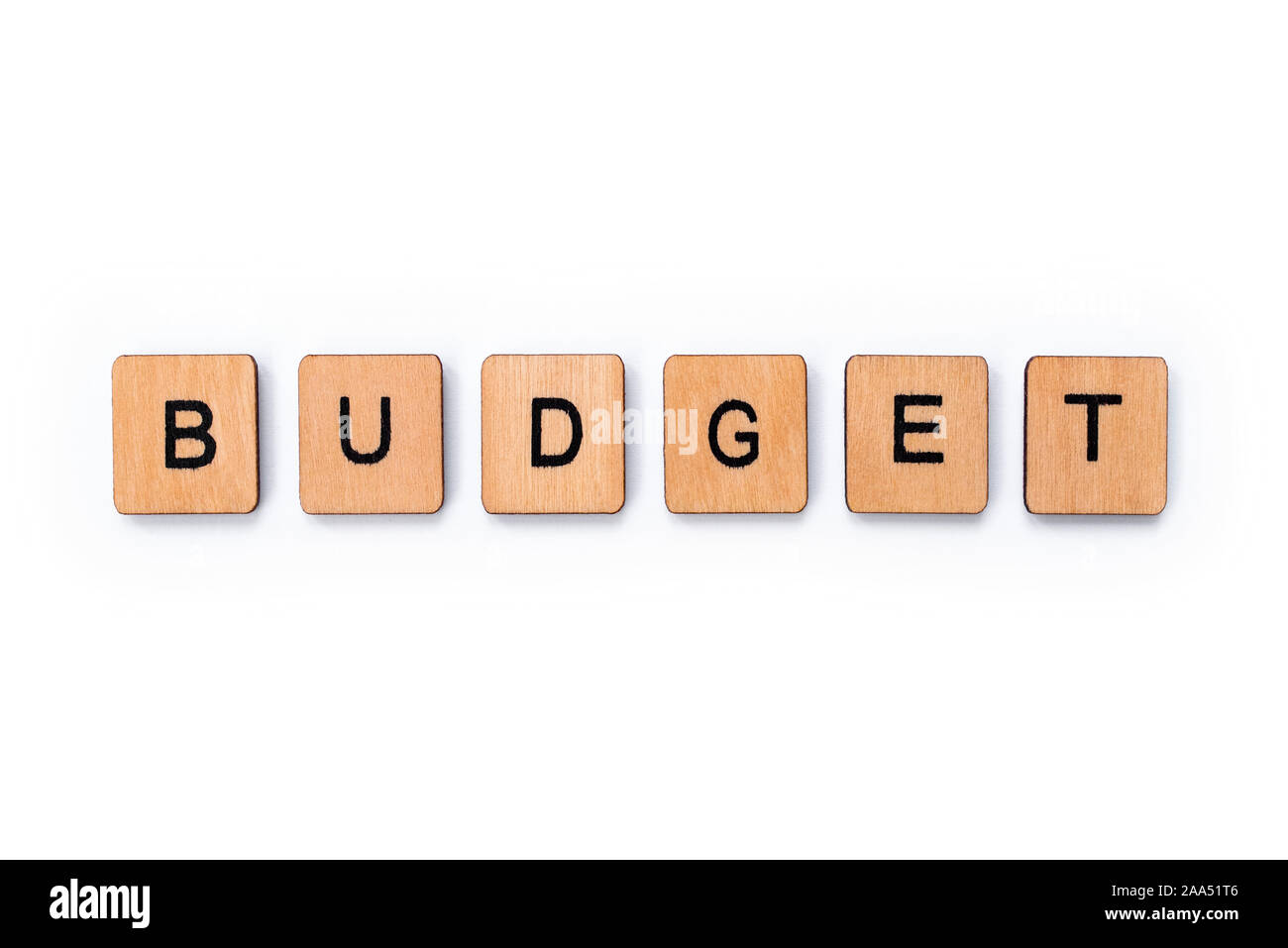 The word BUDGET, spelt with wooden letter tiles over a white background ...