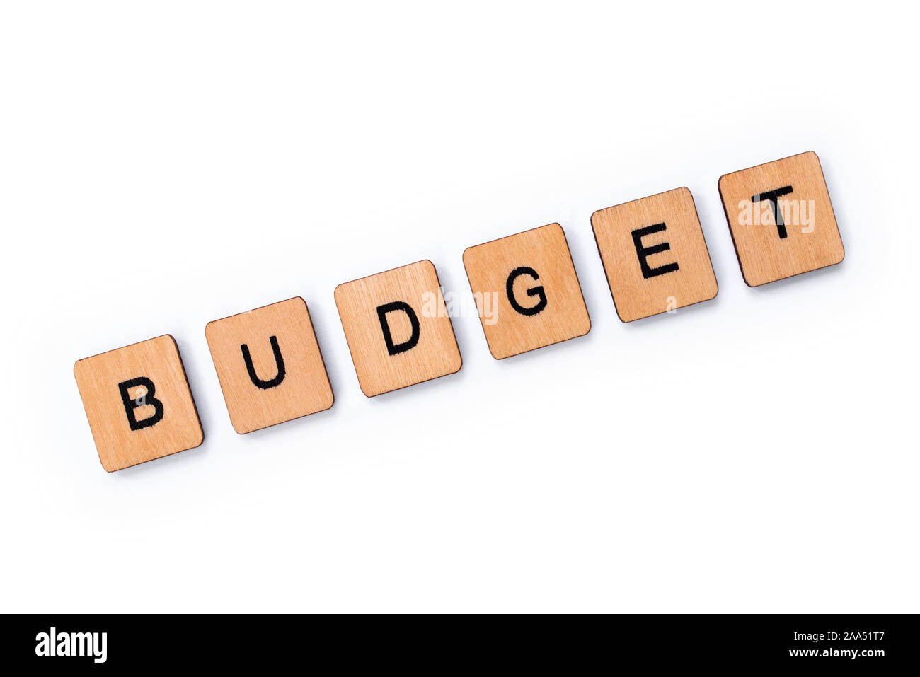 The word BUDGET, spelt with wooden letter tiles over a white background ...