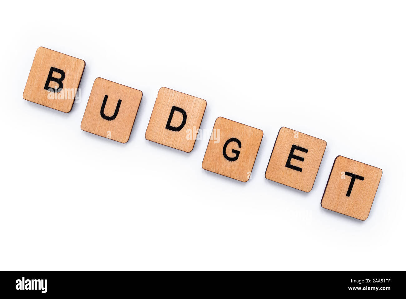The word BUDGET, spelt with wooden letter tiles over a white background ...