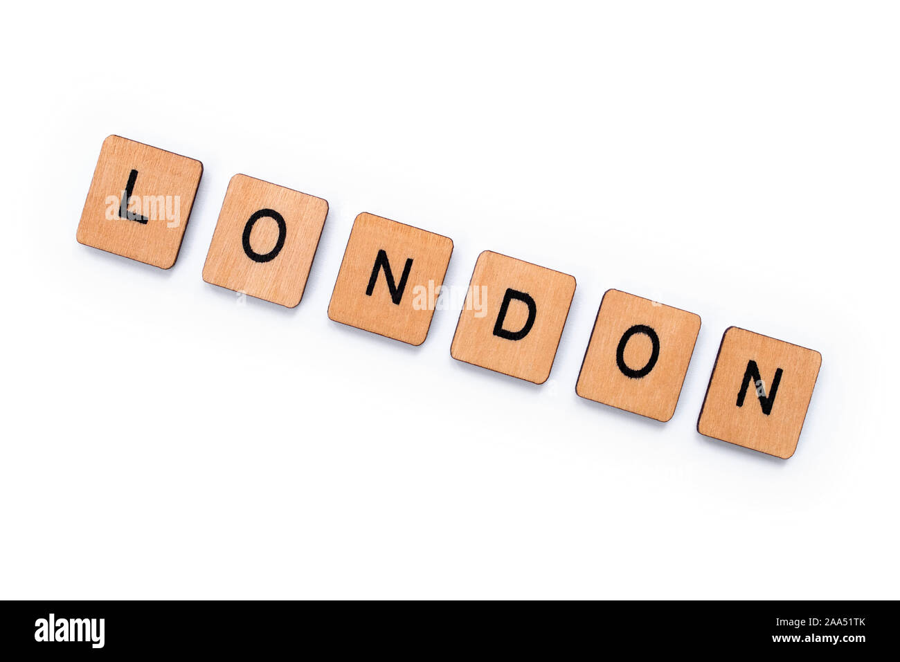 The word LONDON, spelt with wooden letter tiles over a white background ...