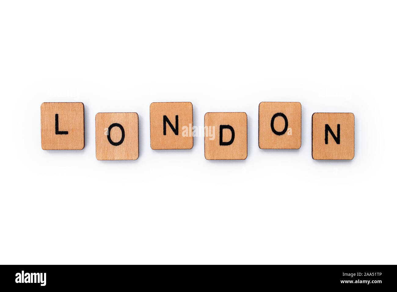 The word LONDON, spelt with wooden letter tiles over a white background ...
