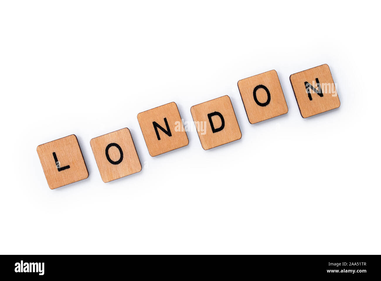 The word LONDON, spelt with wooden letter tiles over a white background ...