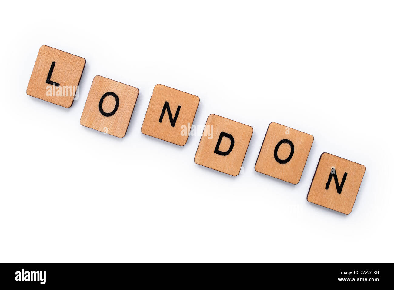 The word LONDON, spelt with wooden letter tiles over a white background ...