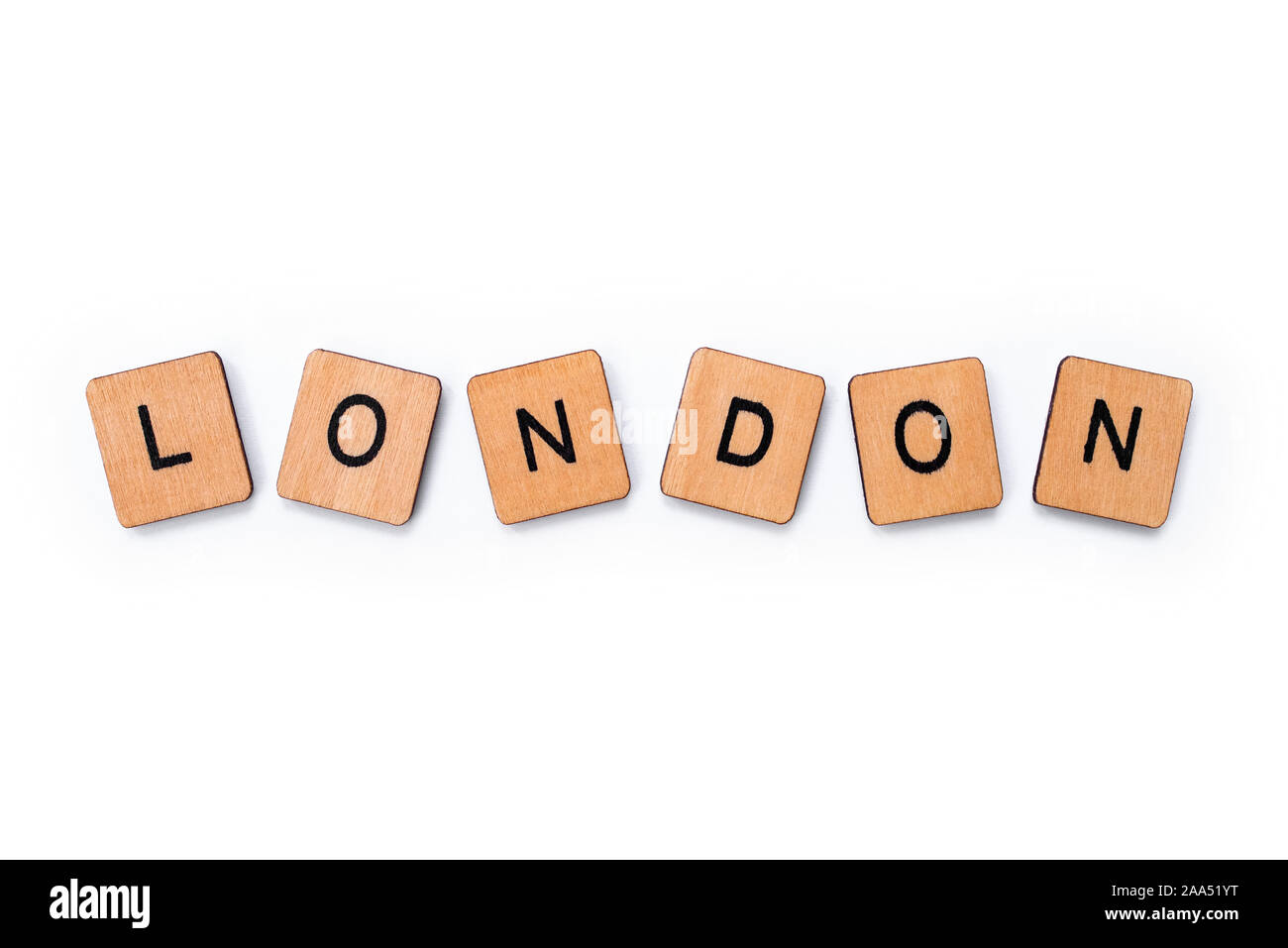 The word LONDON, spelt with wooden letter tiles over a white background ...