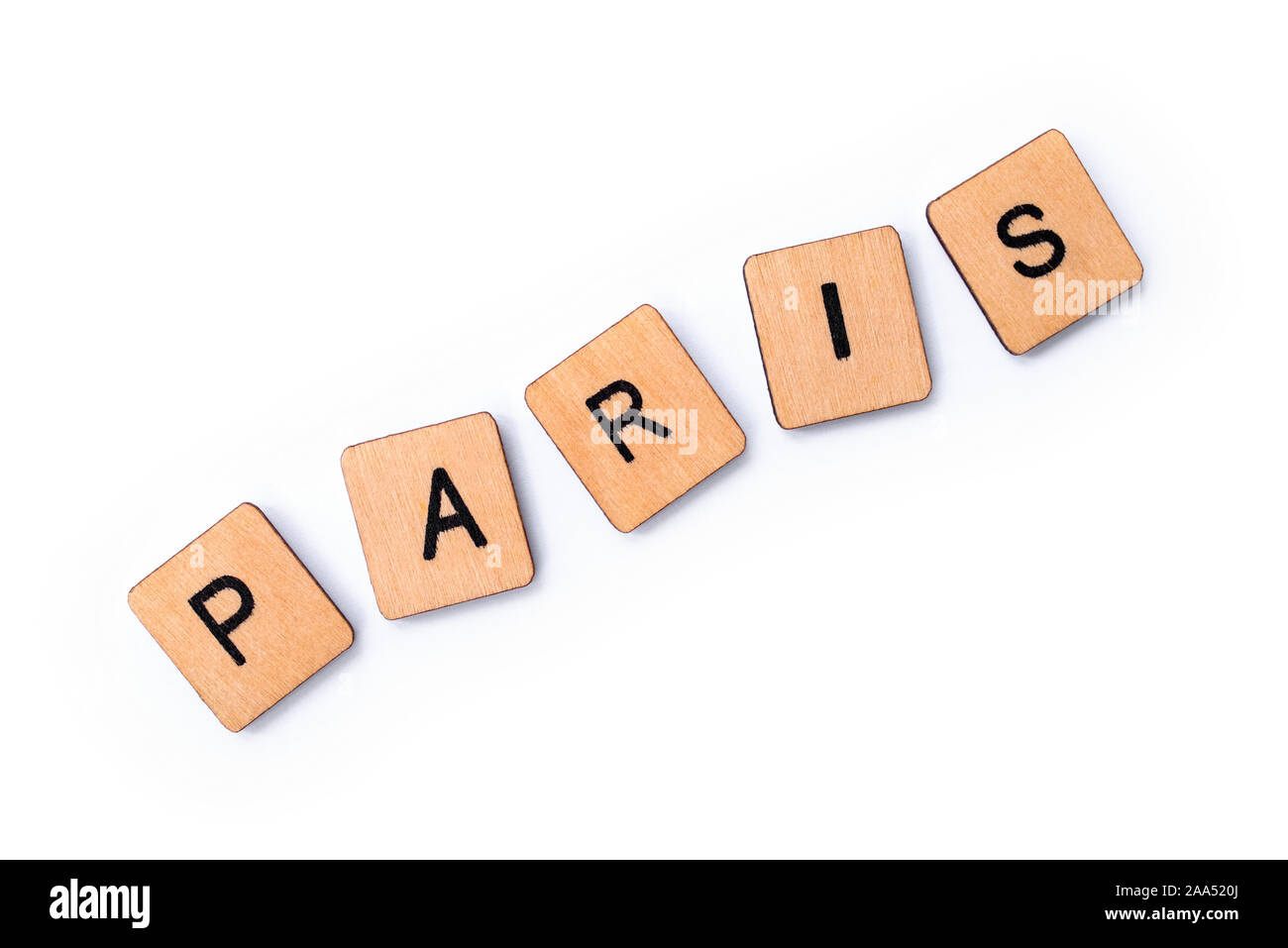The word PARIS, spelt with wooden letter tiles over a white background ...