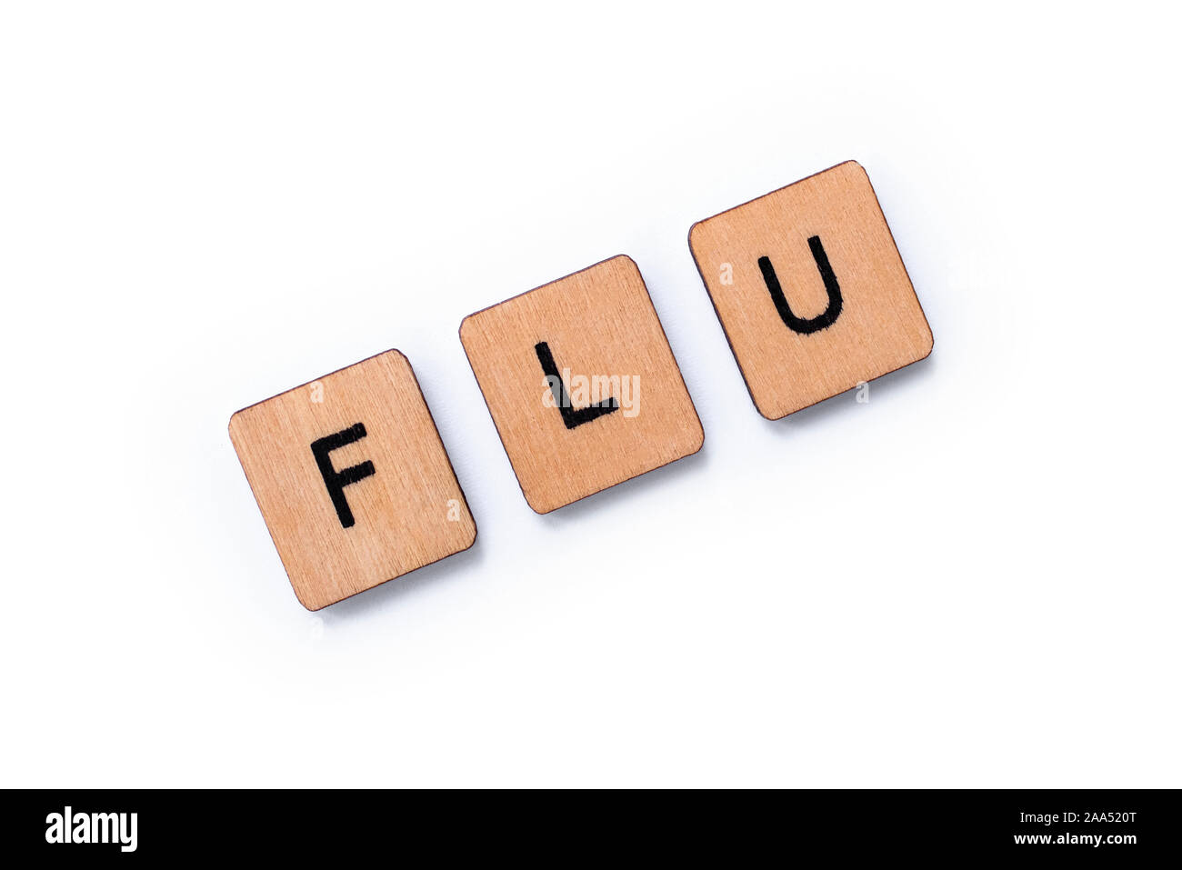 The word FLU, spelt with wooden letter tiles over a white background ...