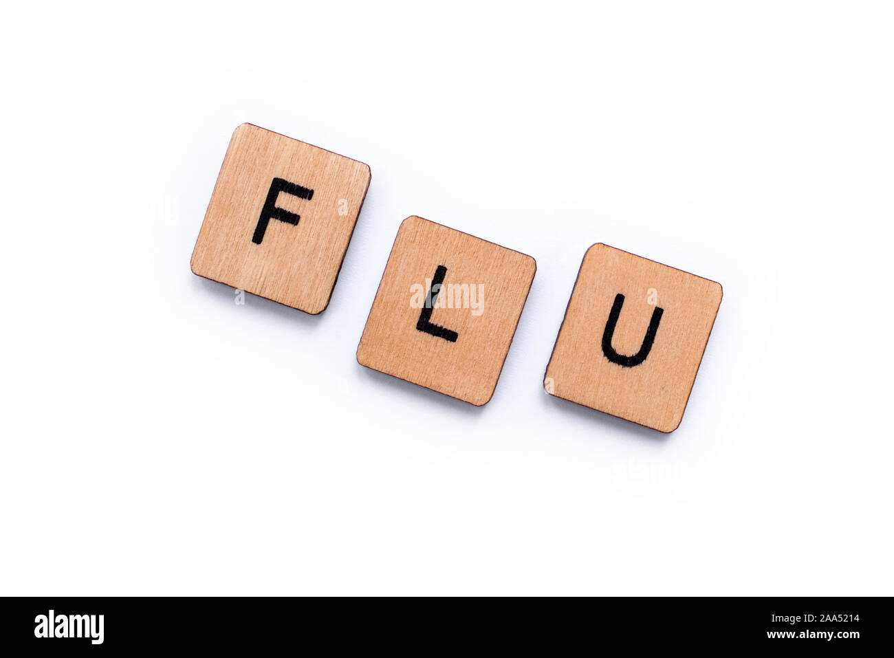 The word FLU, spelt with wooden letter tiles over a white background ...