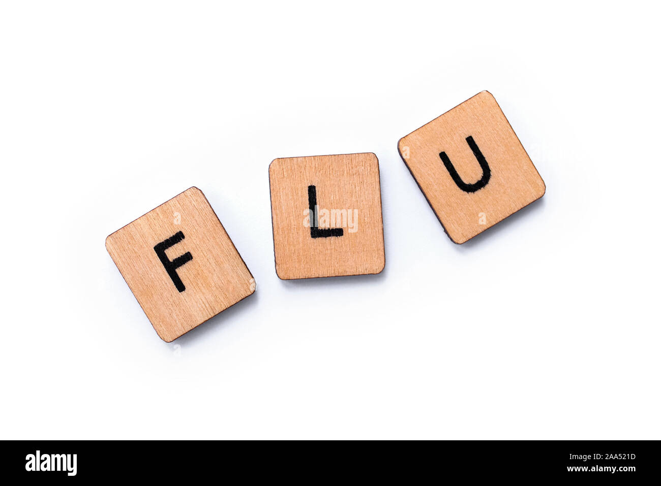 The word FLU, spelt with wooden letter tiles over a white background ...