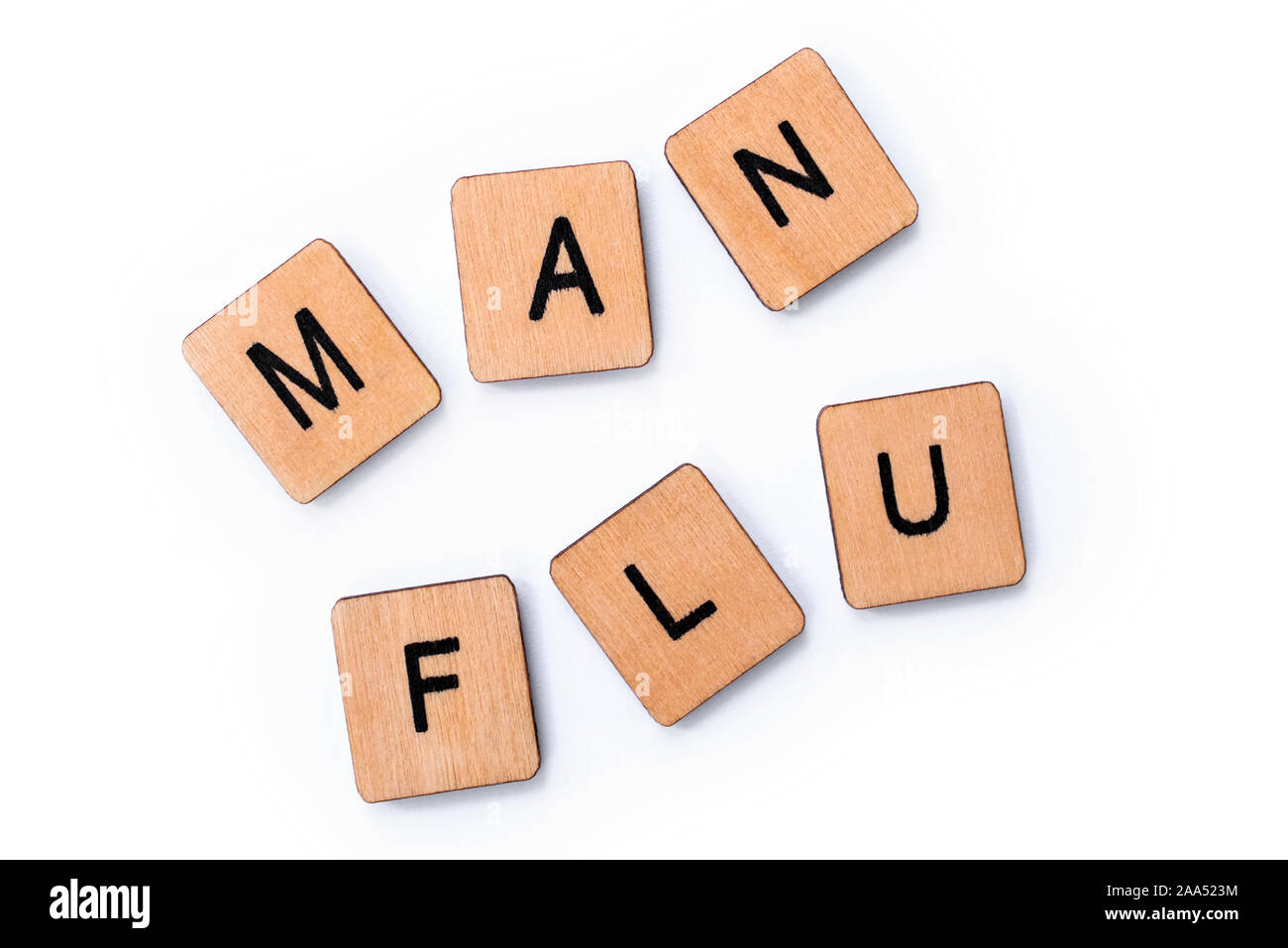 The phrase MAN FLU, spelt with wooden letter tiles over a white ...