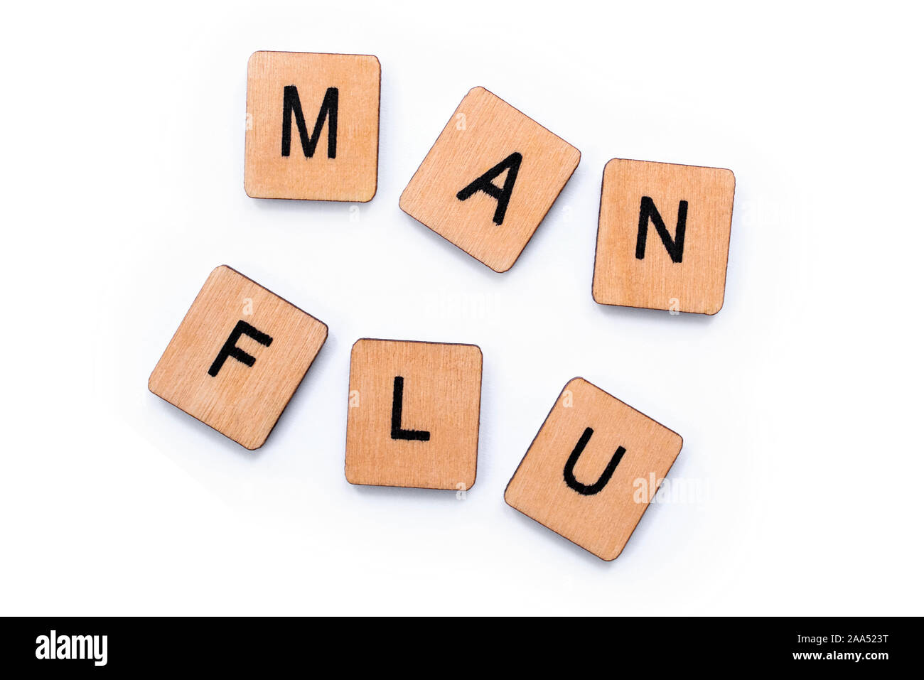 The phrase MAN FLU, spelt with wooden letter tiles over a white ...