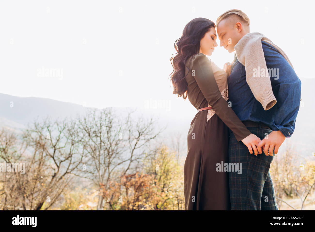 Loving couple at sunset. Stylish Boyfriend and Girlfriend kiss each ...