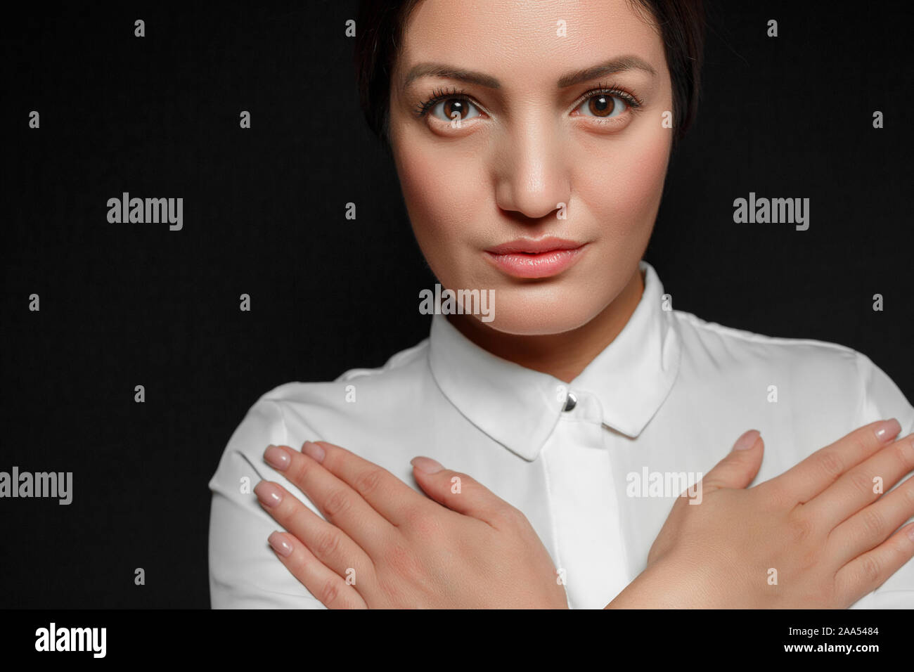 Portrait Of Asian Brunette Woman In White Shirt With Arms Crossed On