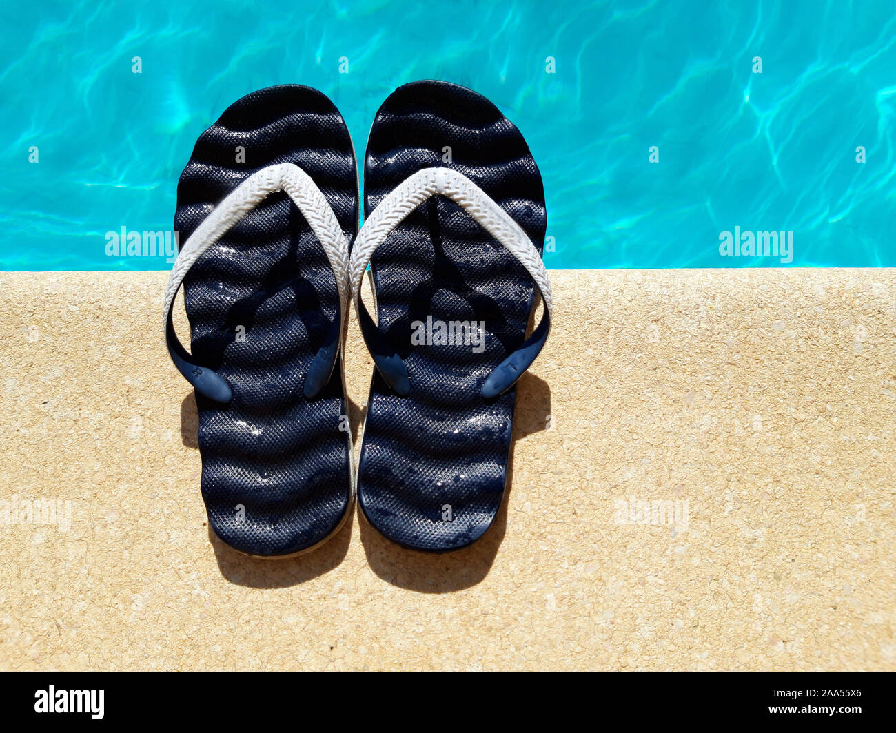 flip flops by the swimming pool. summer concept Stock Photo - Alamy