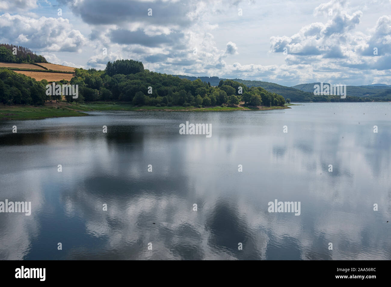 A serene reservoir with woodland and hills in Morvan National Park ...
