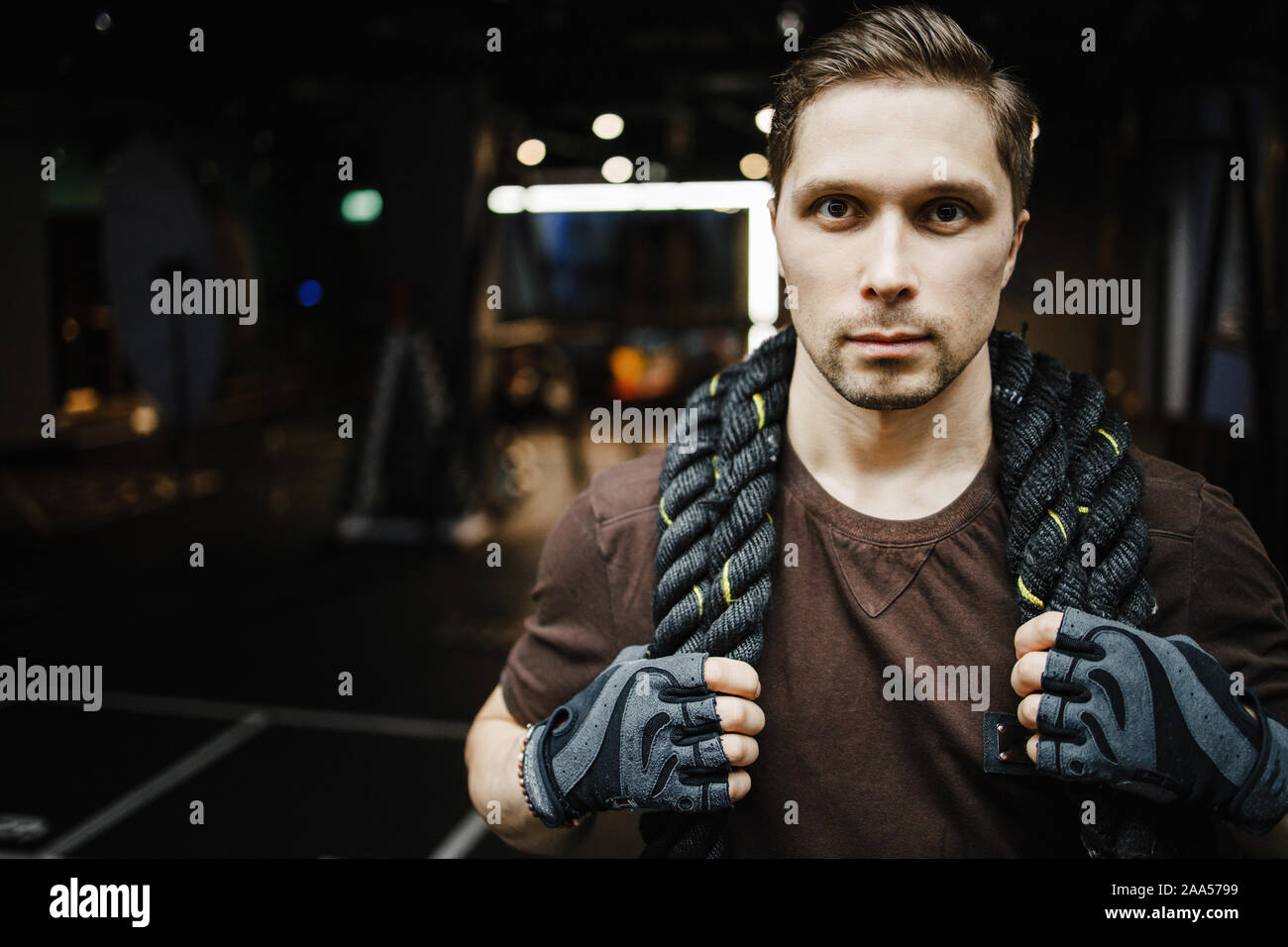 Sportsman with rope on his neck in dark gym Stock Photo - Alamy