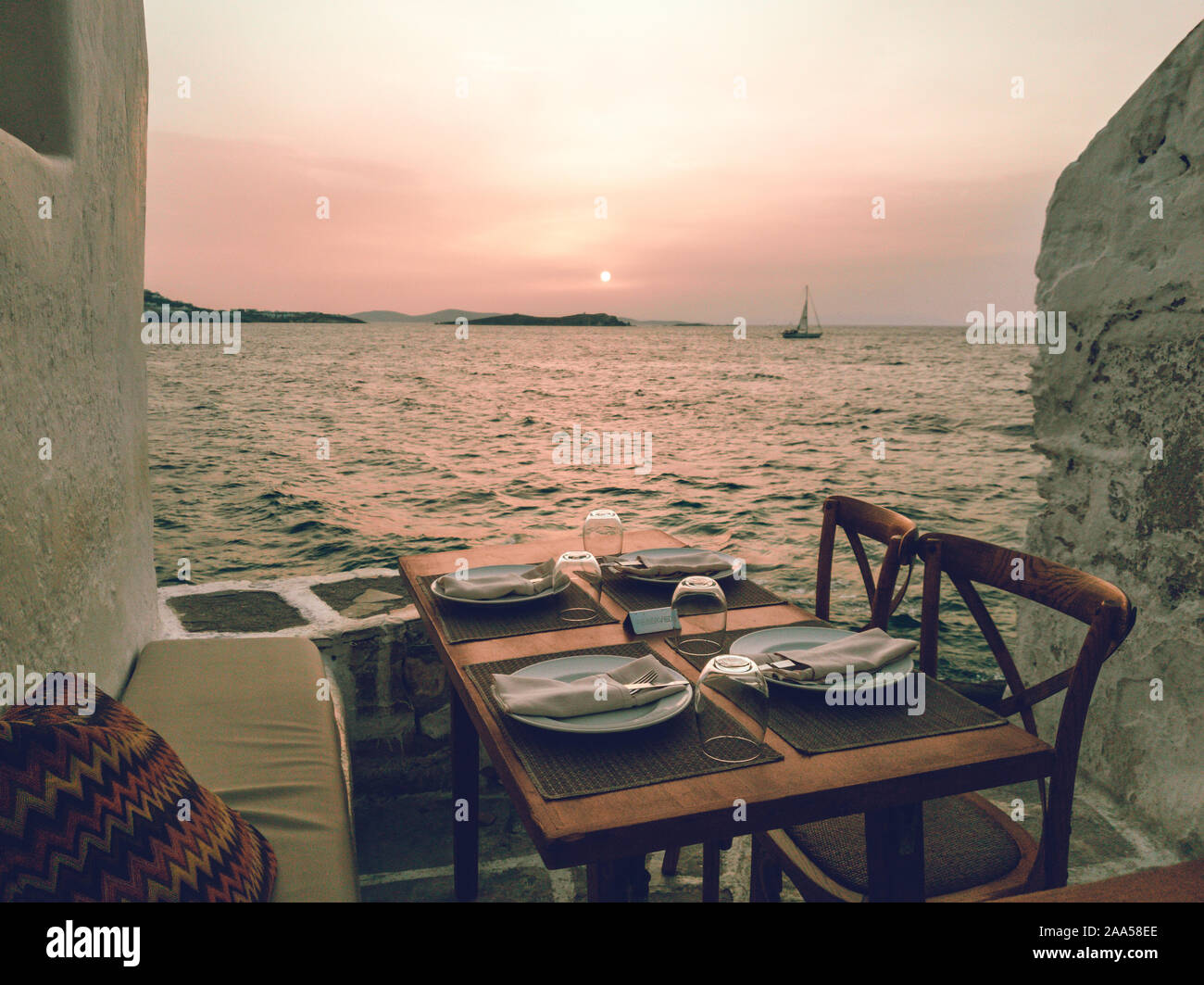 Table on beach side food joint with beautiful view, Mykonos, Greece ...