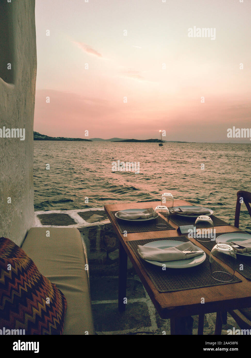 Table on beach side food joint with beautiful view, Mykonos, Greece ...
