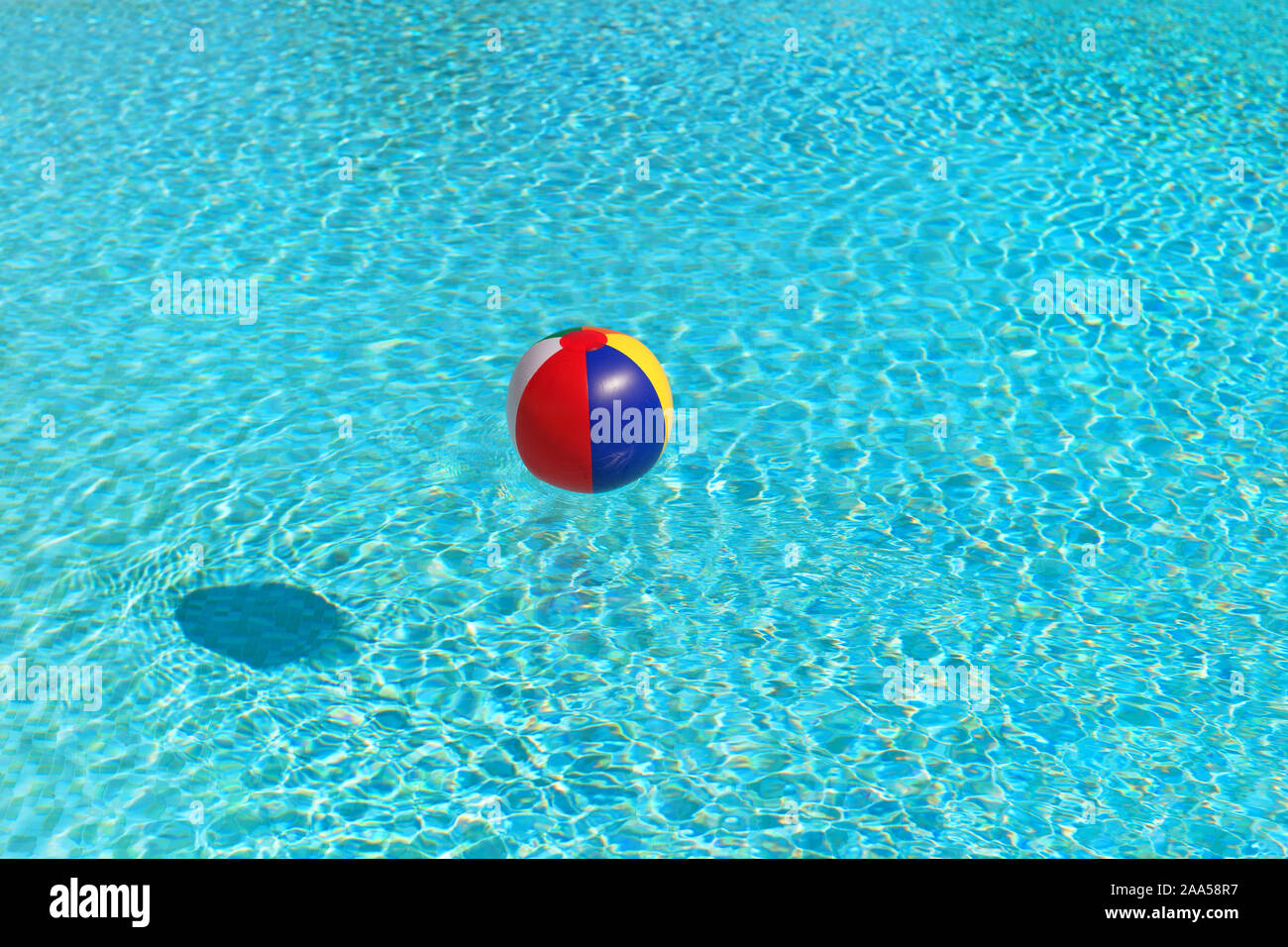 Inflatable colorful beach ball floating in water Stock Photo - Alamy