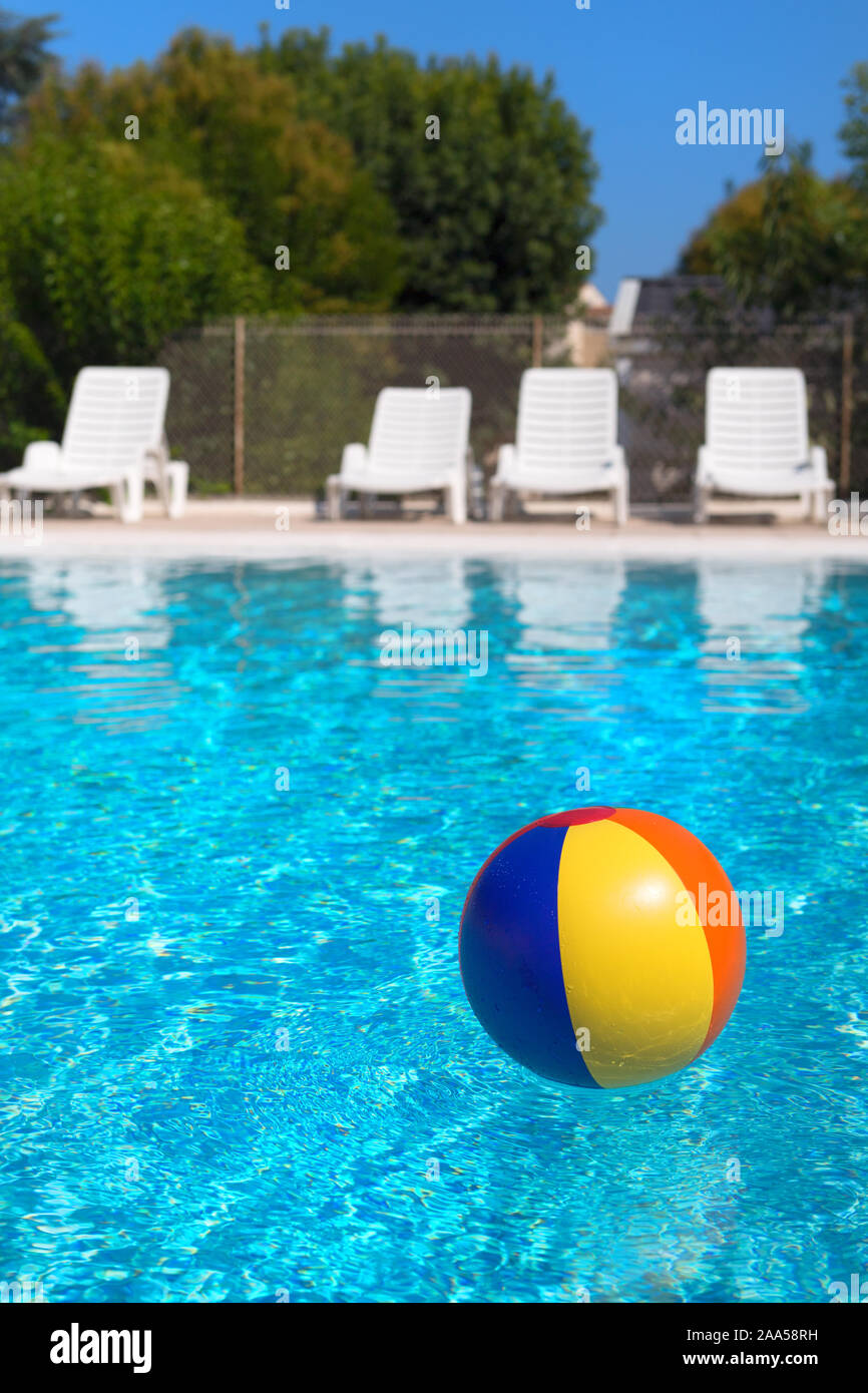 Inflatable colorful beach ball floating in water Stock Photo - Alamy