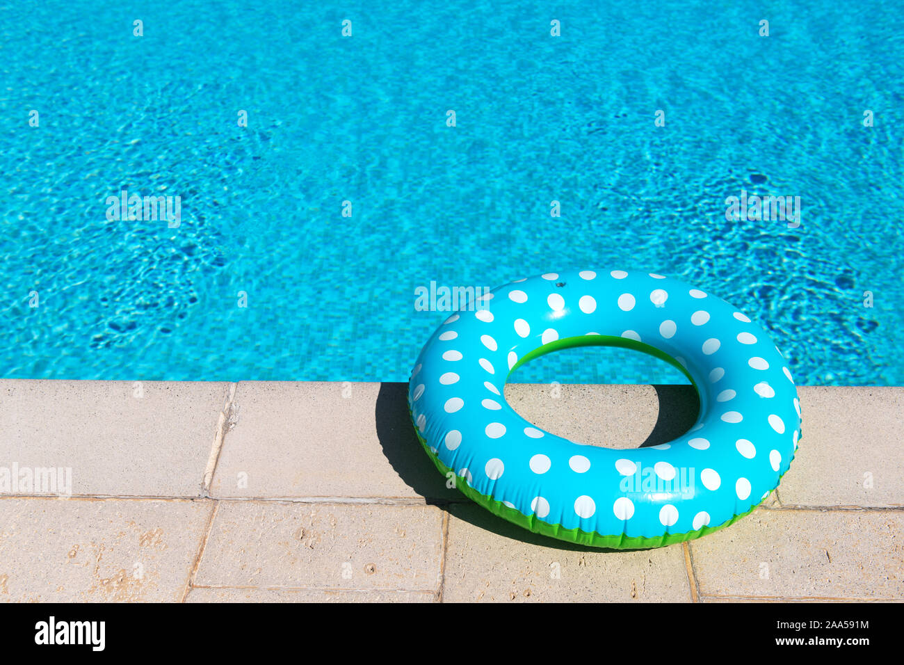 Floating ring toy in blue and green with swimming pool Stock Photo - Alamy