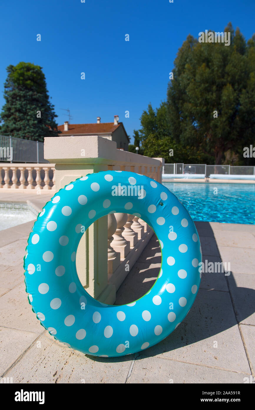 Floating ring toy in blue and green with swimming pool Stock Photo - Alamy