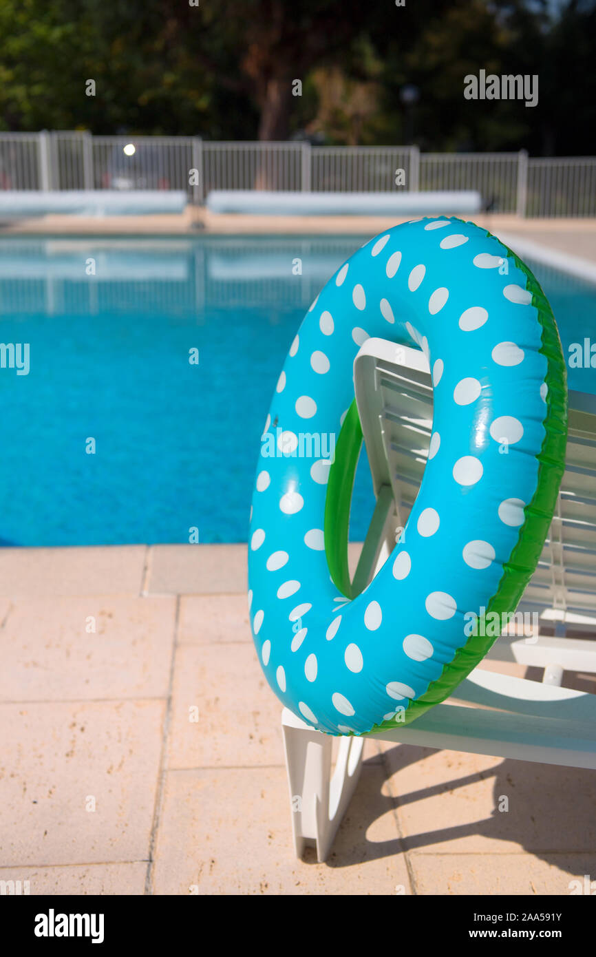 Spotted blue inflatable ring in swimming pool Stock Photo - Alamy