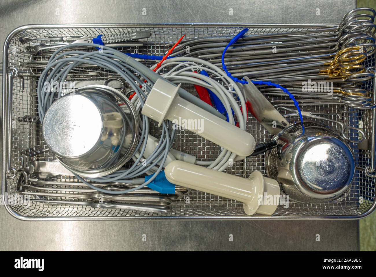 a tray for surgical instruments contains various assorted instruments ...