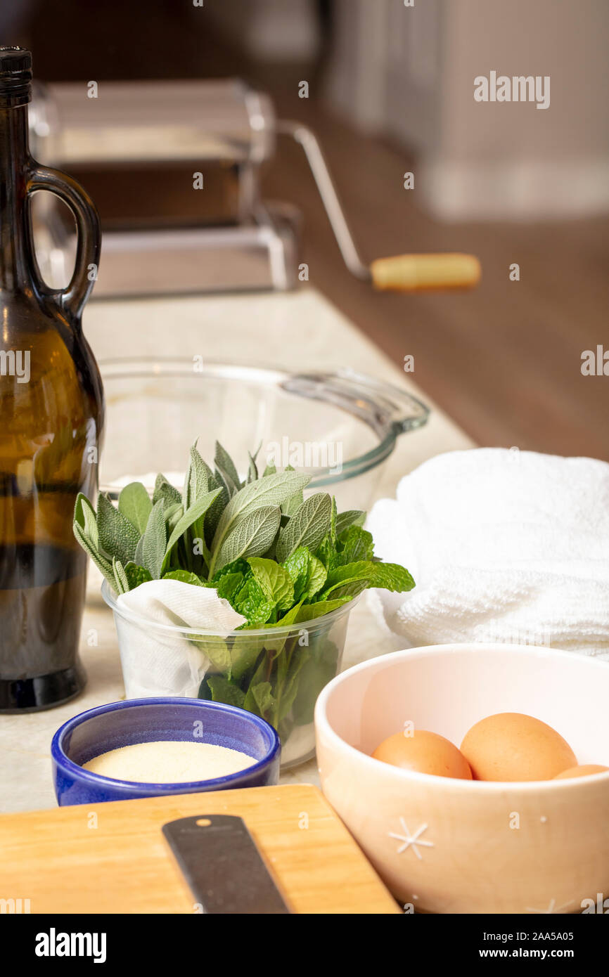 Sage in a container, and food items and utensils on a kitchen ...