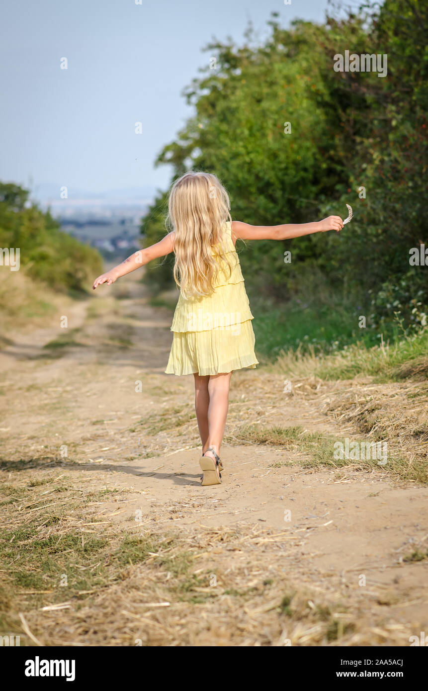 girl with long blond hair flying in the air jumping and dancing in free ...