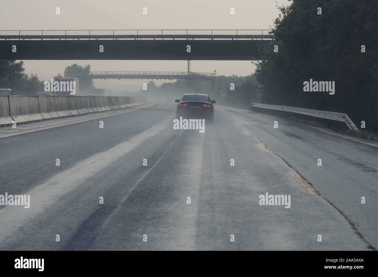 traffic in slippery and wet highway road in dangerous stormy and rainy ...