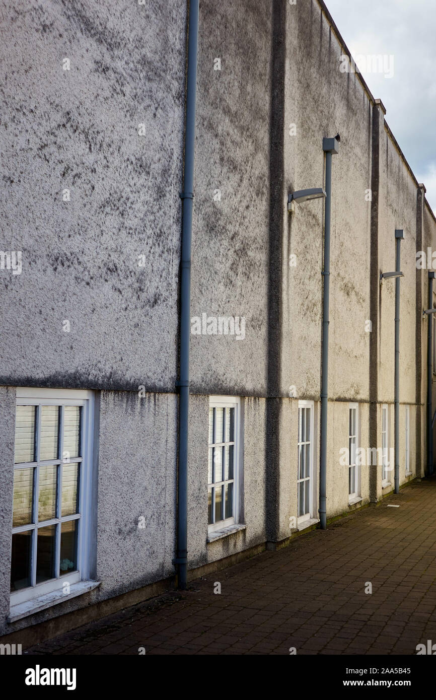 Angled side view of commercial building showing multi paned windows and ...