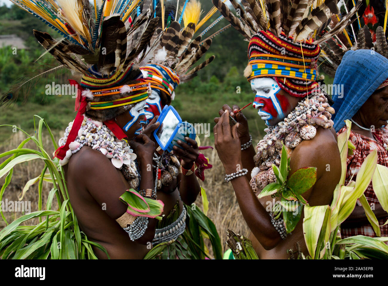 Two performers applying finishing touches Stock Photo - Alamy
