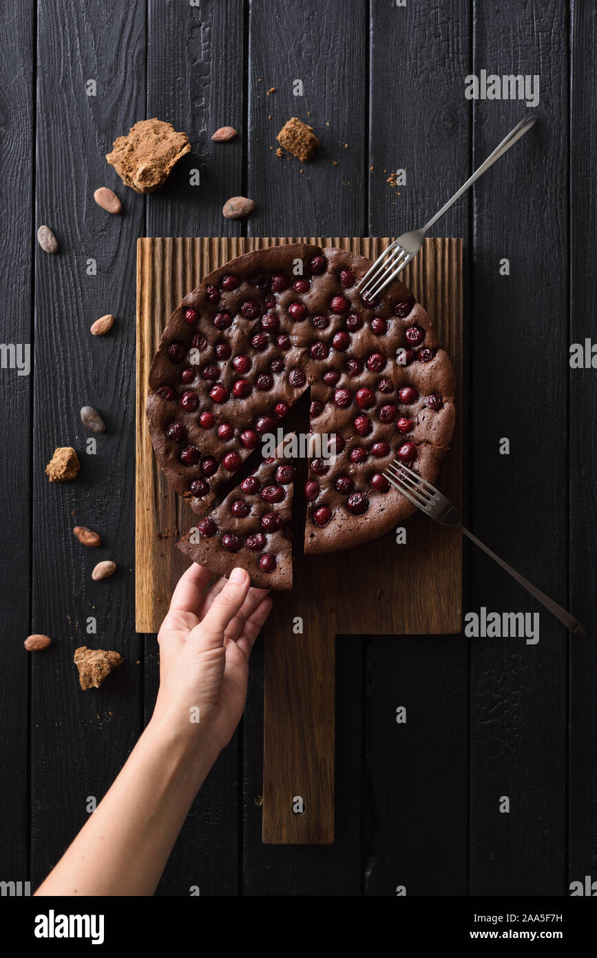 Indulgent chocolate dessert. Thin woman hand reaching for chocolate ...